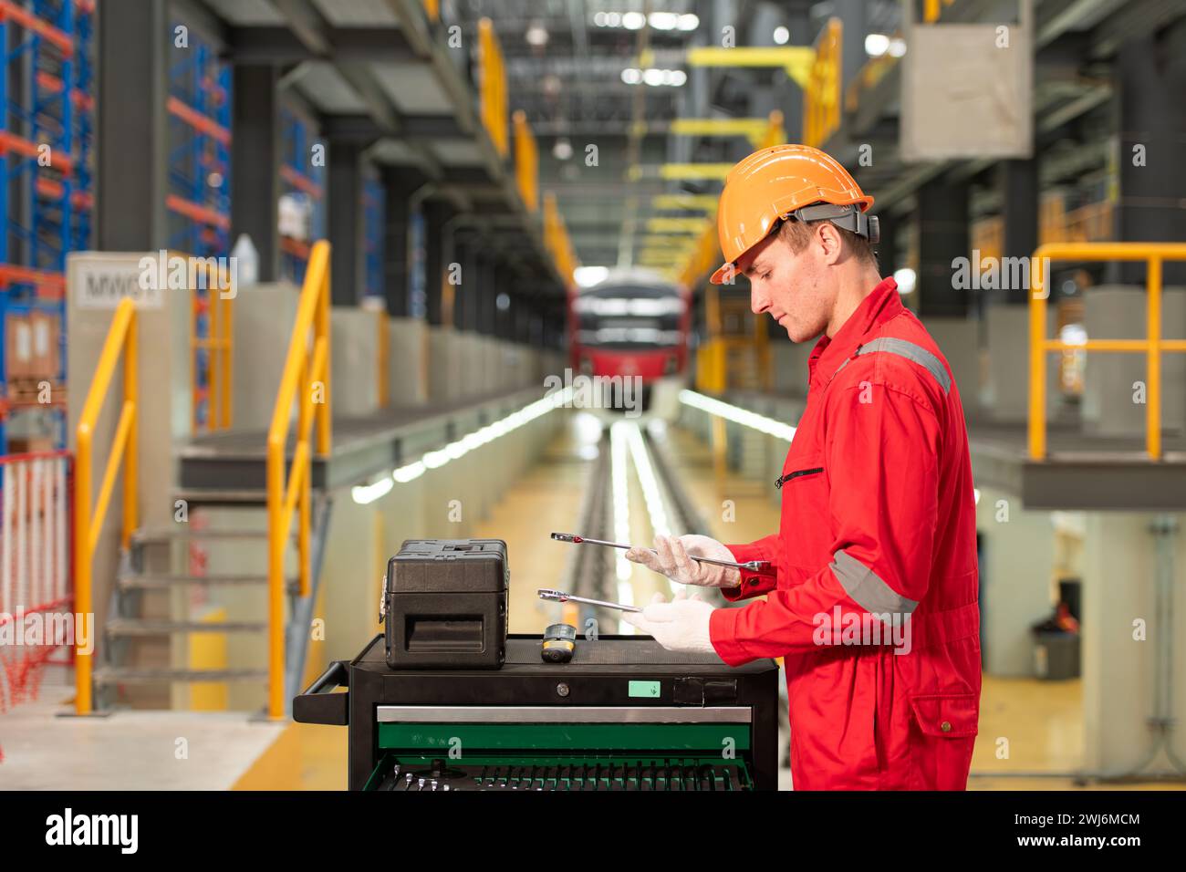 Portrait of engineer using repair tools of the electric train industry ...