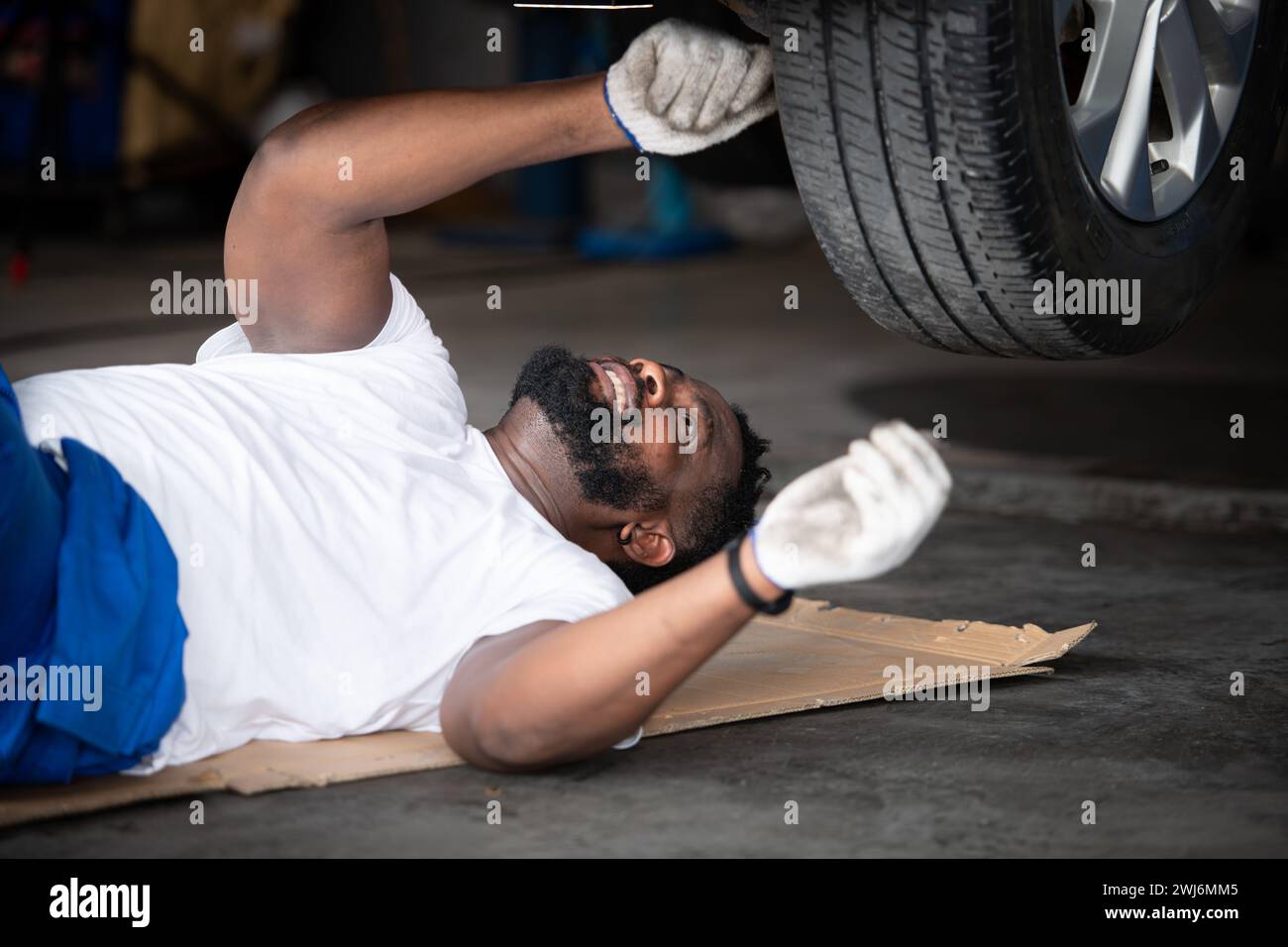 Car mechanic working in an auto repair shop, Check the operation of the ...