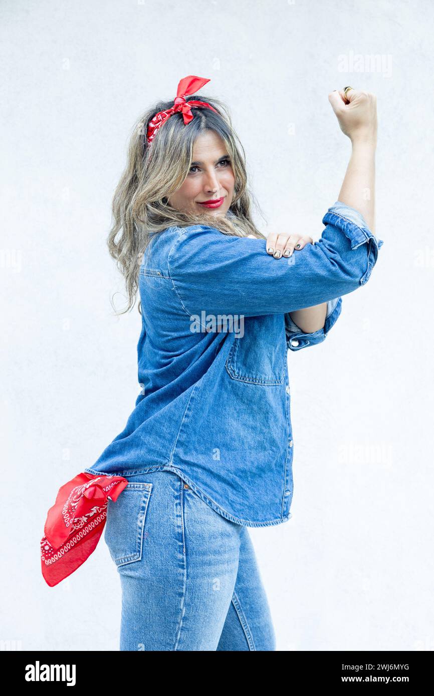 A woman poses with determination and strength, her fist raised high ...