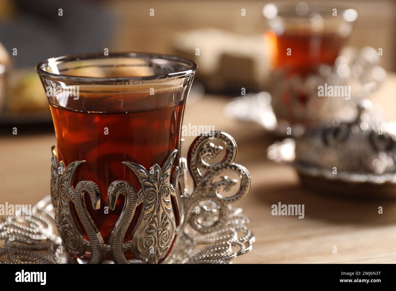 Glass of traditional Turkish tea in vintage holder on table, closeup ...