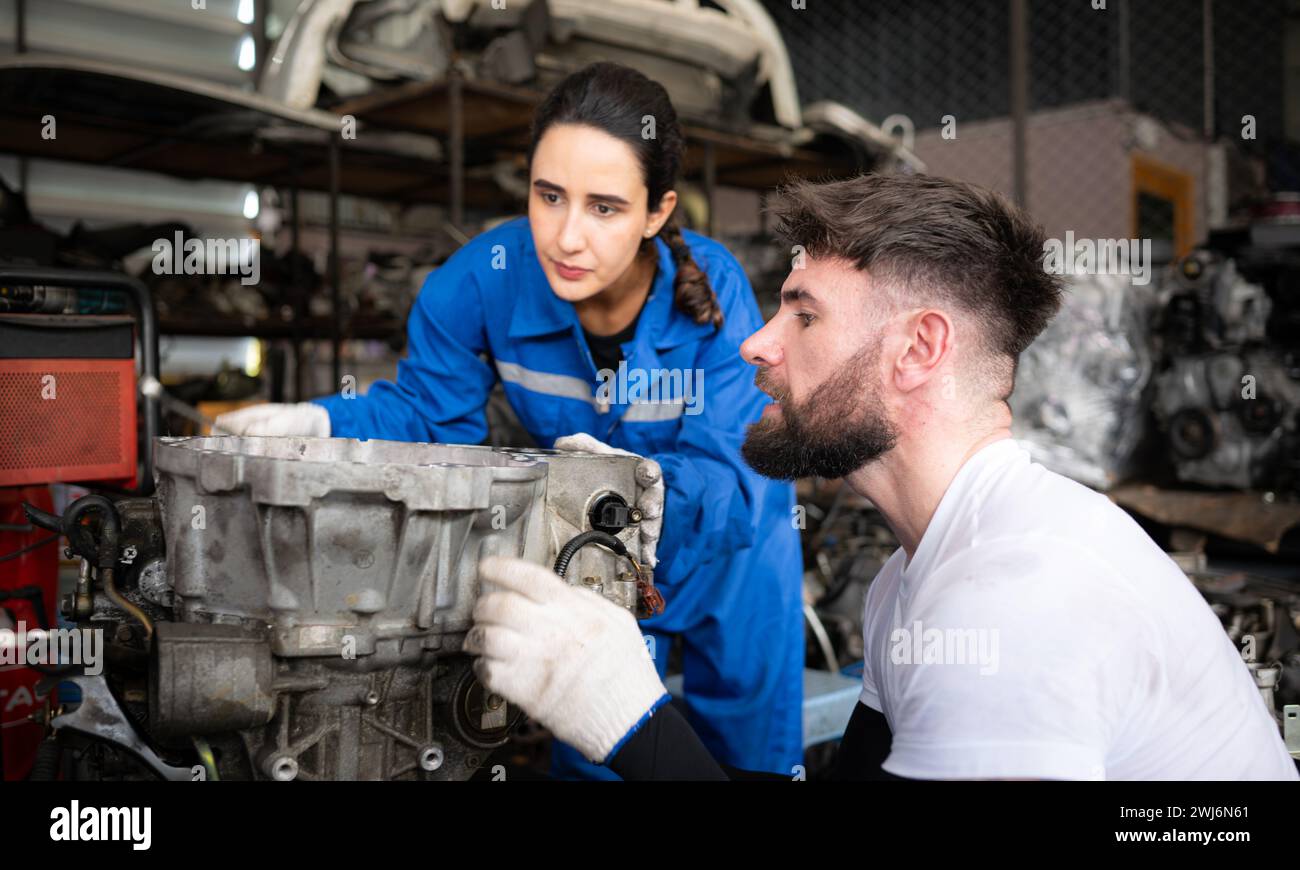 Two men repairing car engine in auto repair shop, Selective focus Stock ...