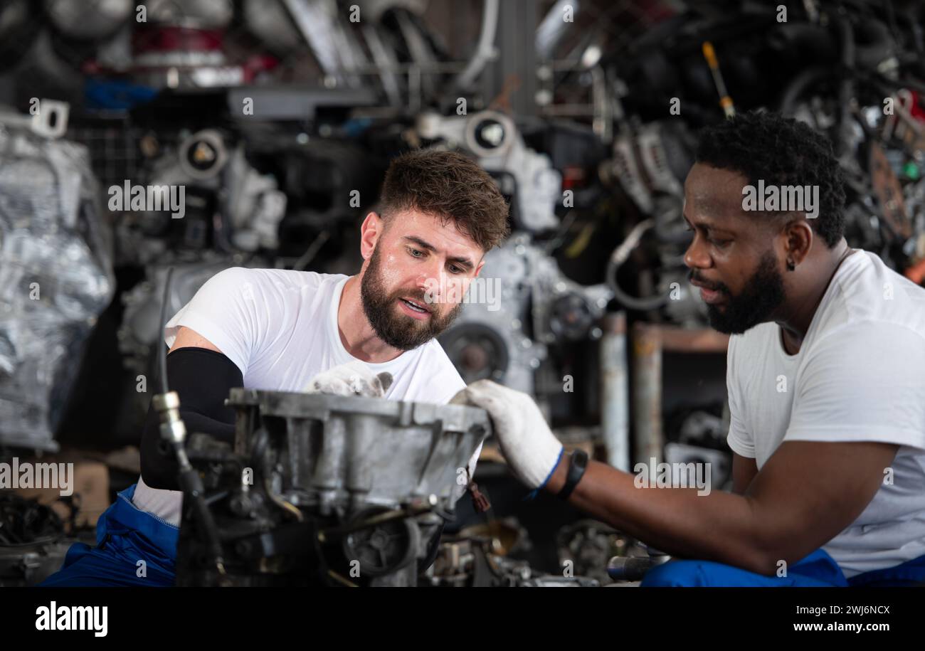 Two men repairing car engine in auto repair shop, Selective focus Stock ...