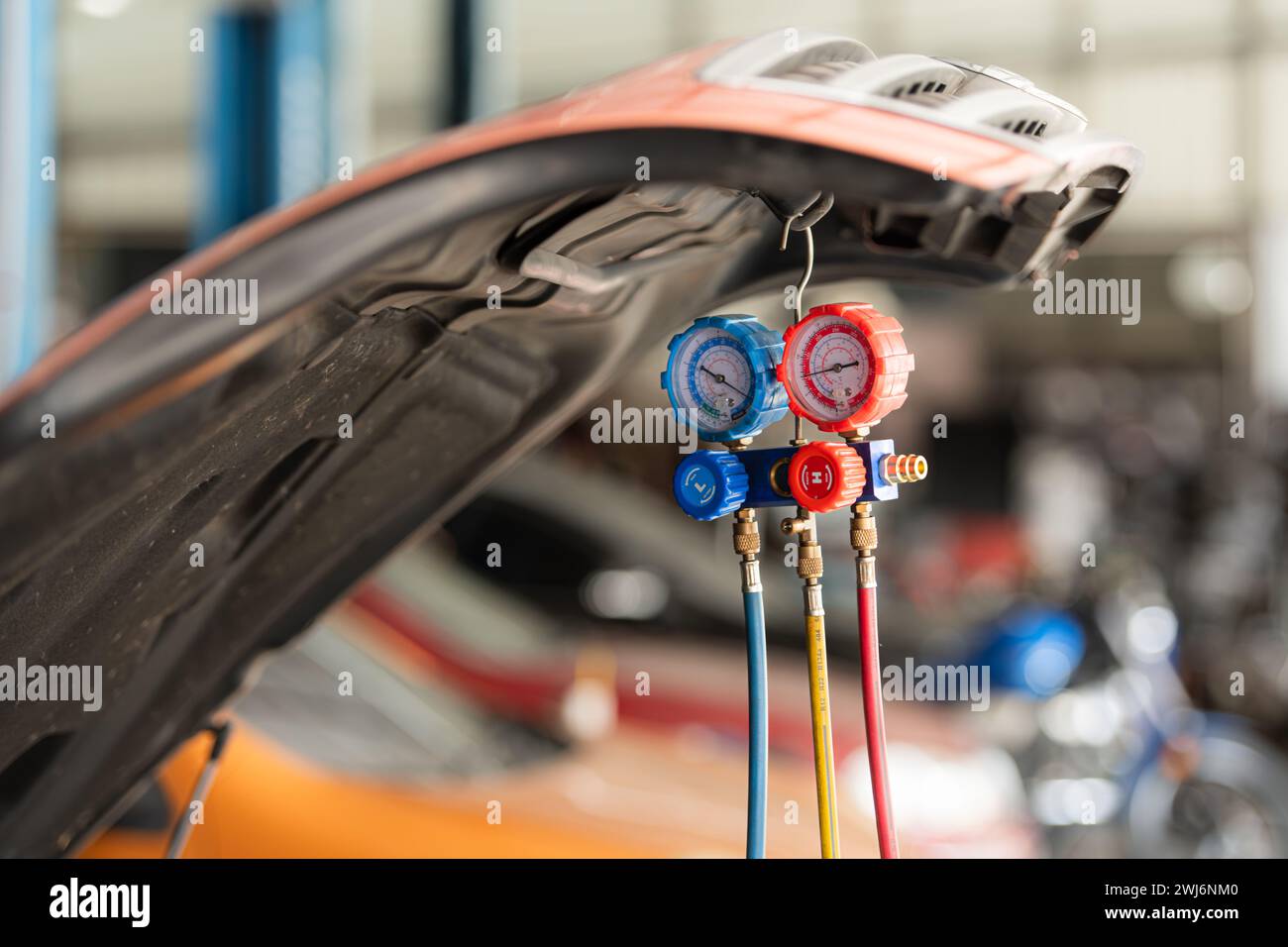 Car mechanic working in auto repair shop, inspecting the operation of ...