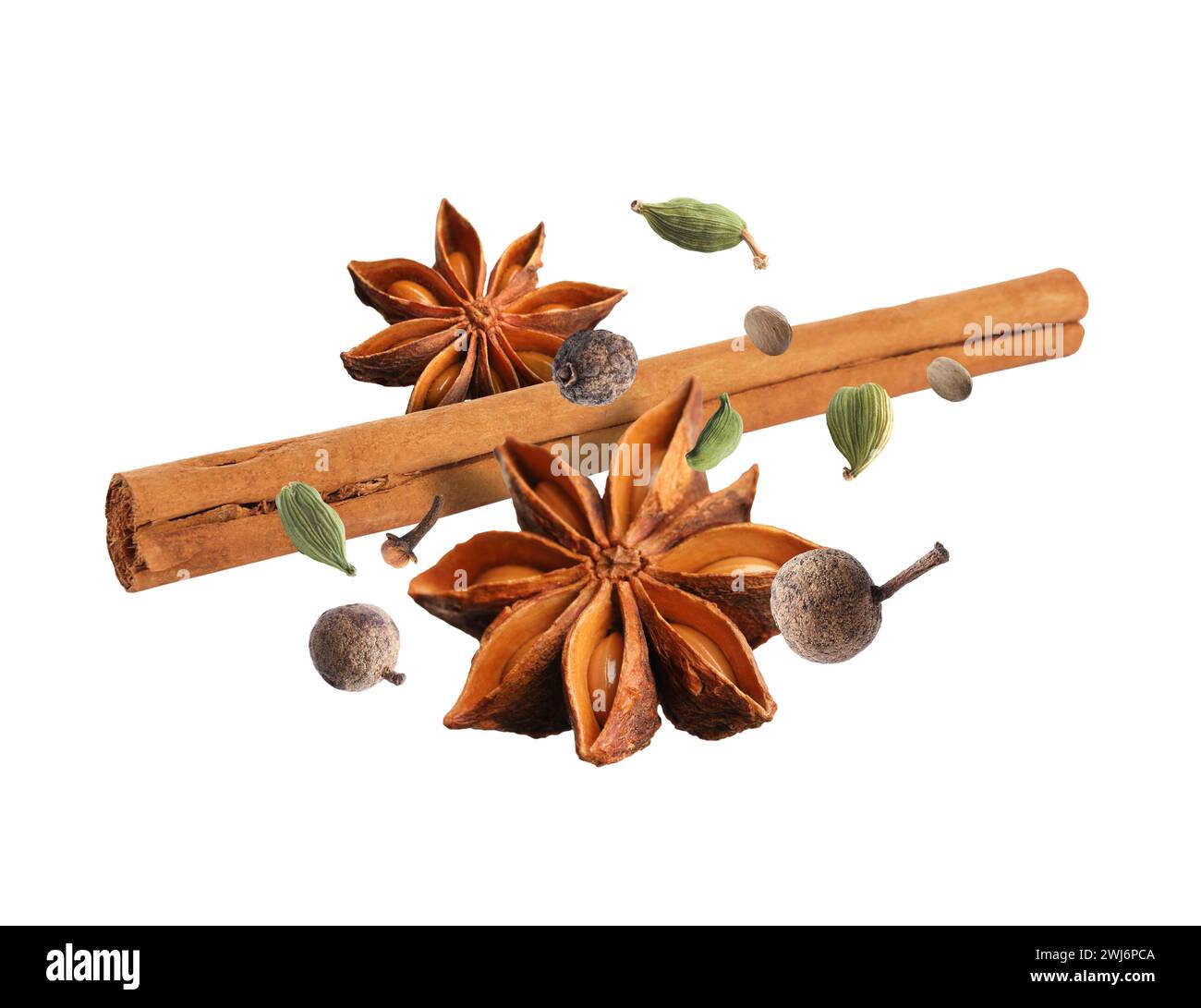 Different aromatic spices falling on white background Stock Photo - Alamy