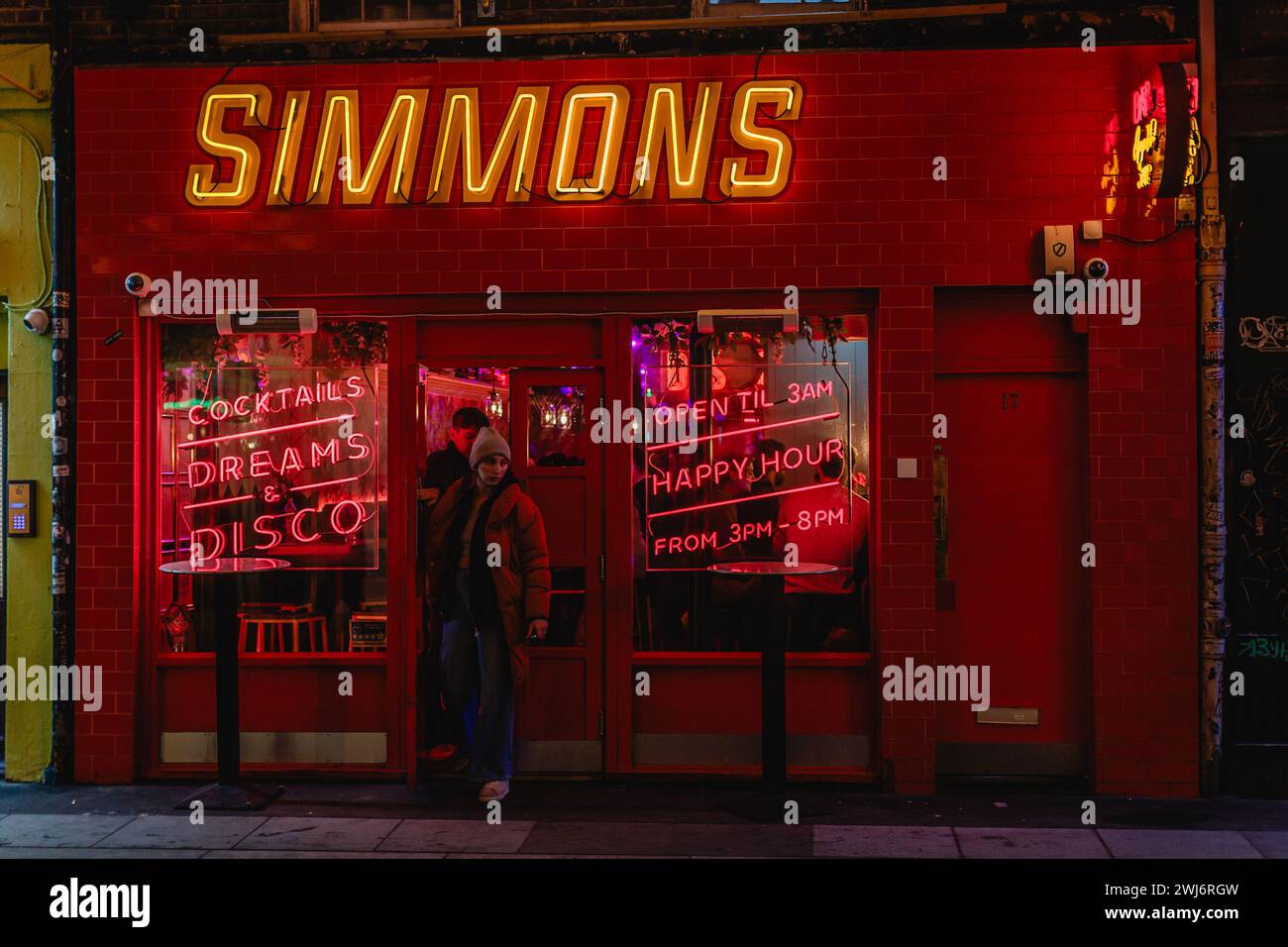 Cocktails, Dreams and Disco neon sign in the window of the Simmons bar ...