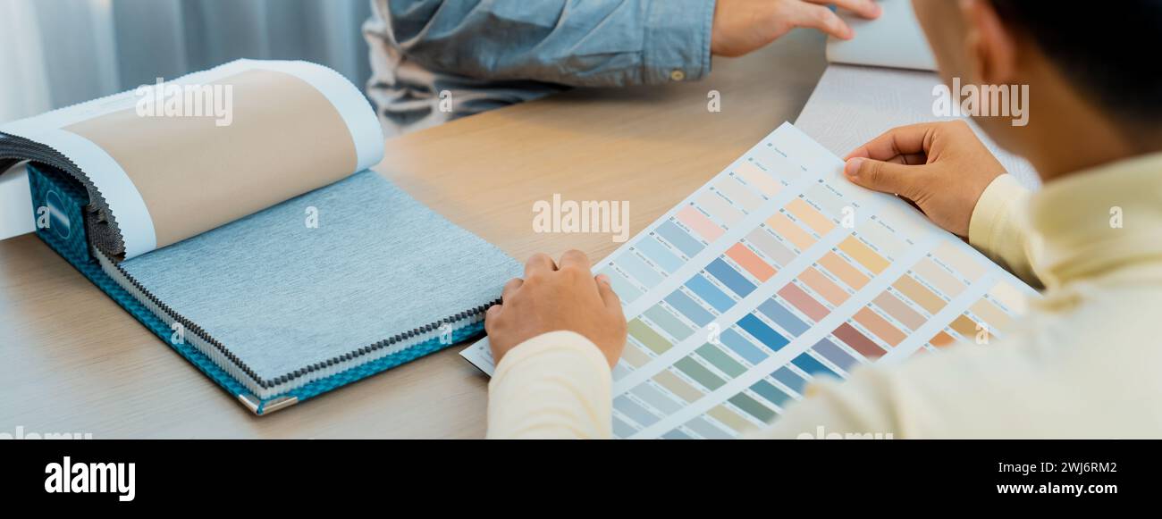 Professional architect and interior designer discussing about curtain ...