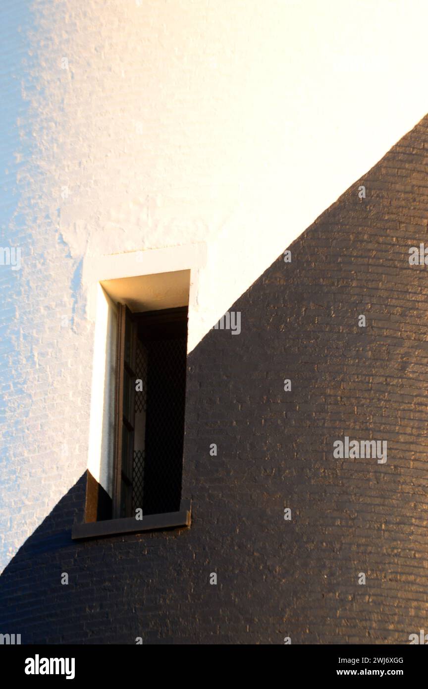 A detail of a window cut by the swirling black and white stripes on the ...