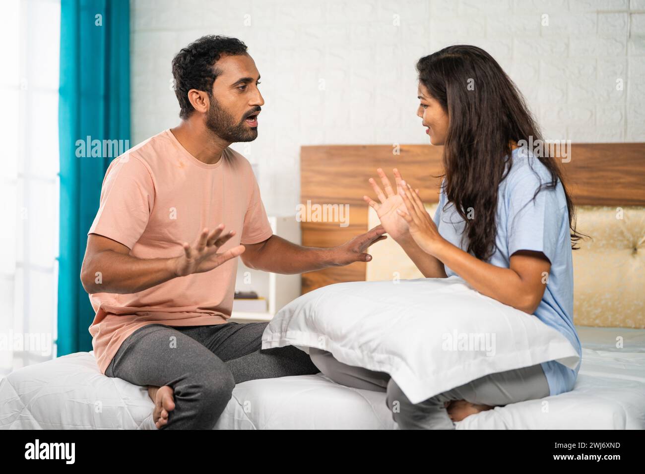 Angry Indian couple arguing each other at bedroom while sleeping ...