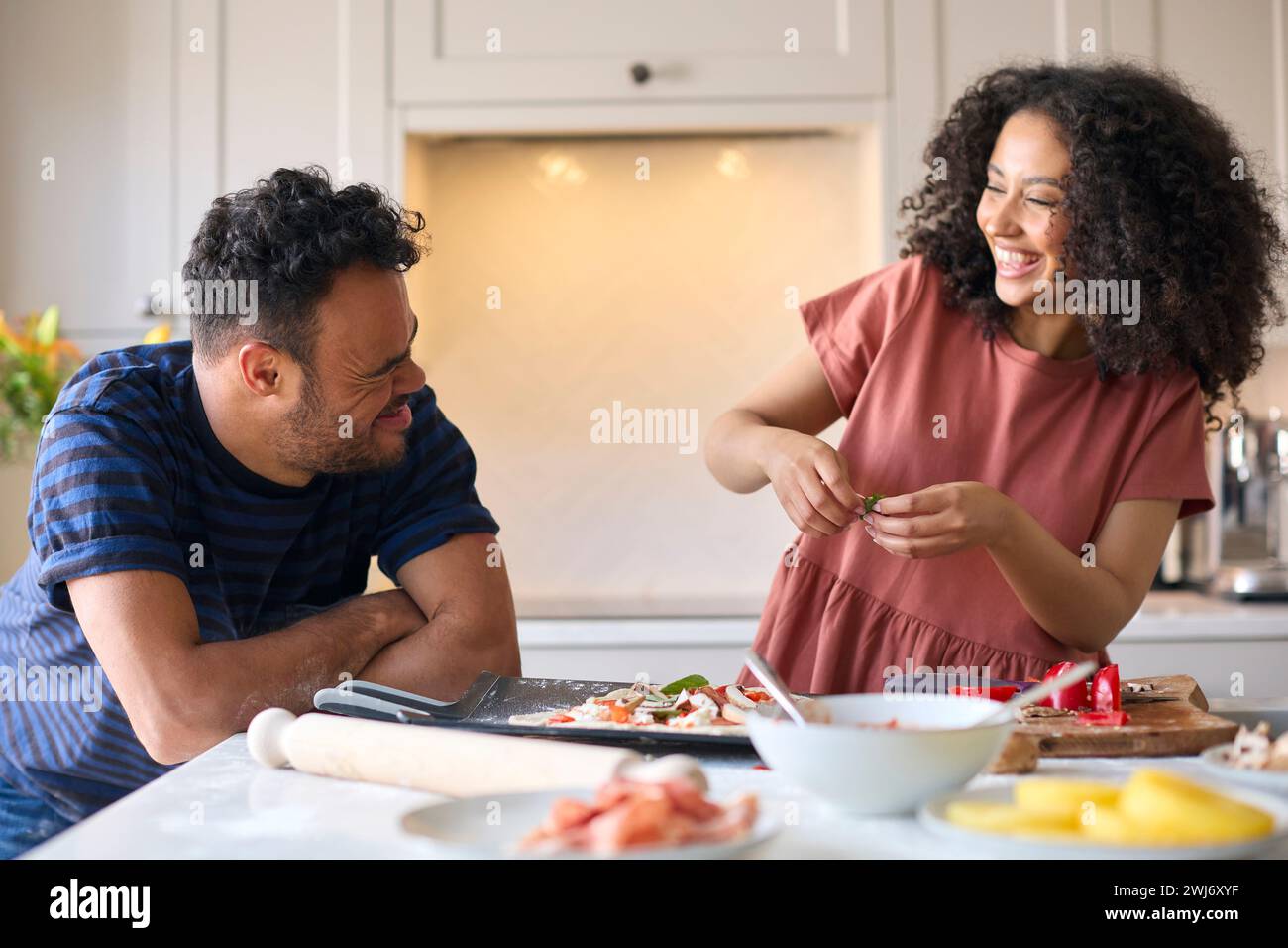 Couple At Home With Man With Down Syndrome And Woman Putting Toppings ...