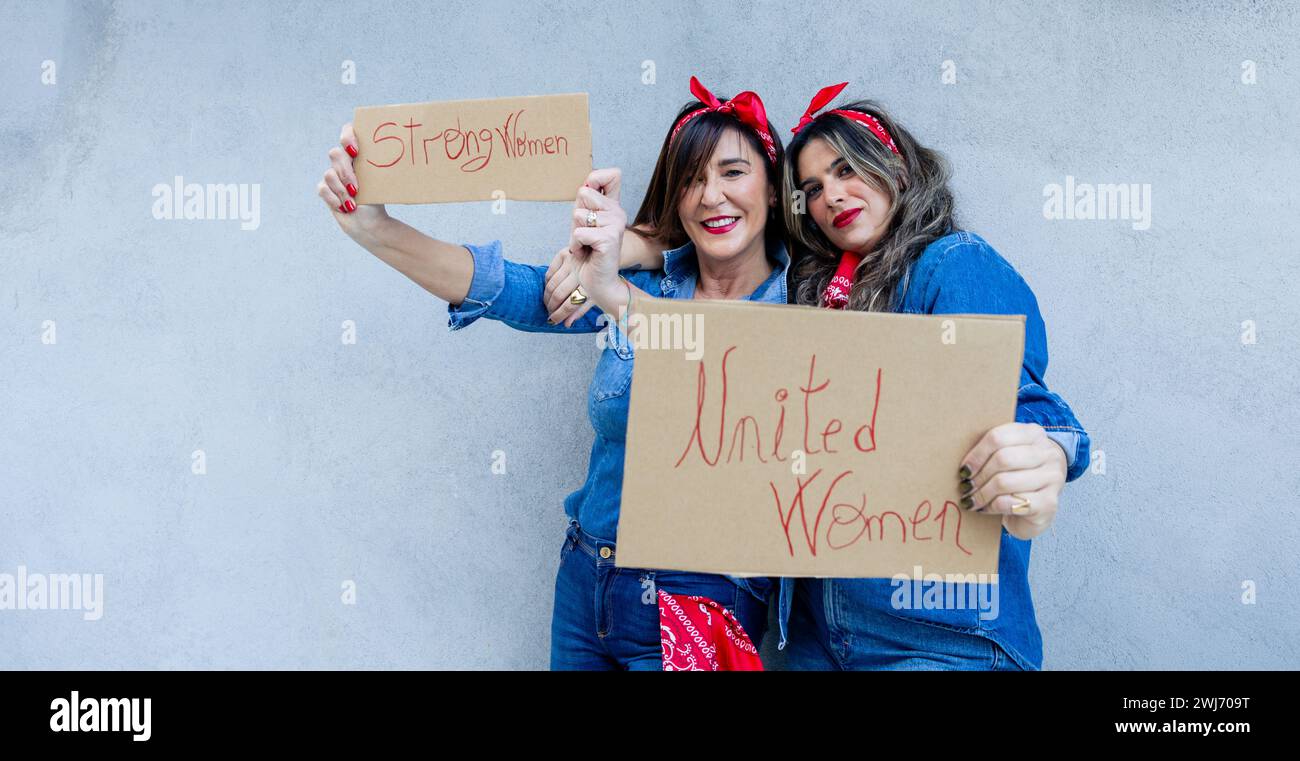 Two enthusiastic women share a moment of solidarity, taking a selfie ...