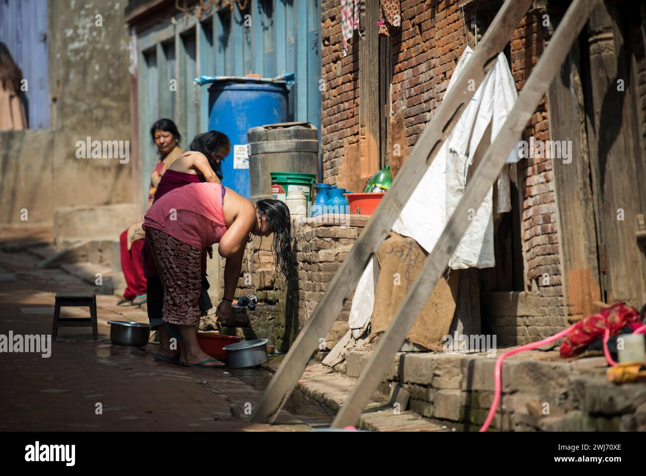 Kathmandu, Nepal- April 20,2023 : Women wash clothes and dishes on the ...