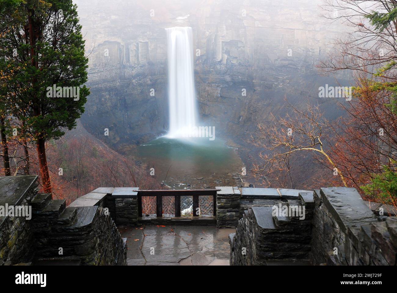 A waterfall cascades into a gorge on a rainy autumn day in Taughannock ...