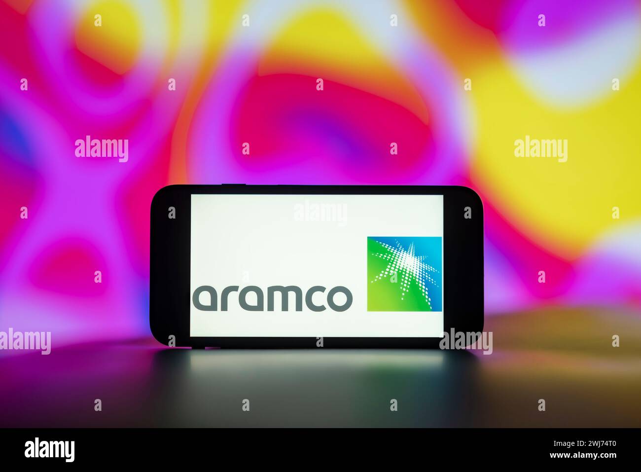 In this photo illustration, the Aramco logo is seen displayed on a ...