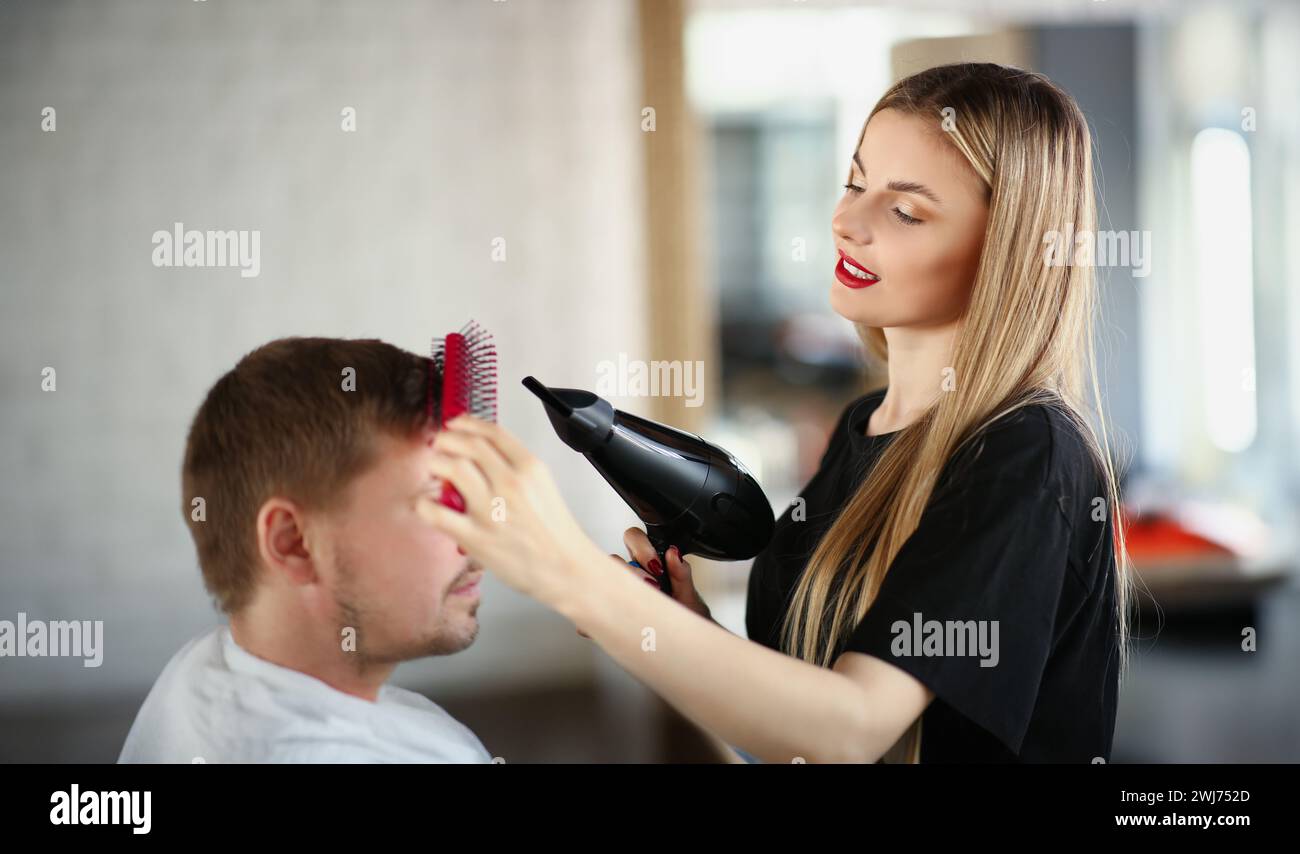 Attractive barber doing haircut hi-res stock photography and images - Alamy