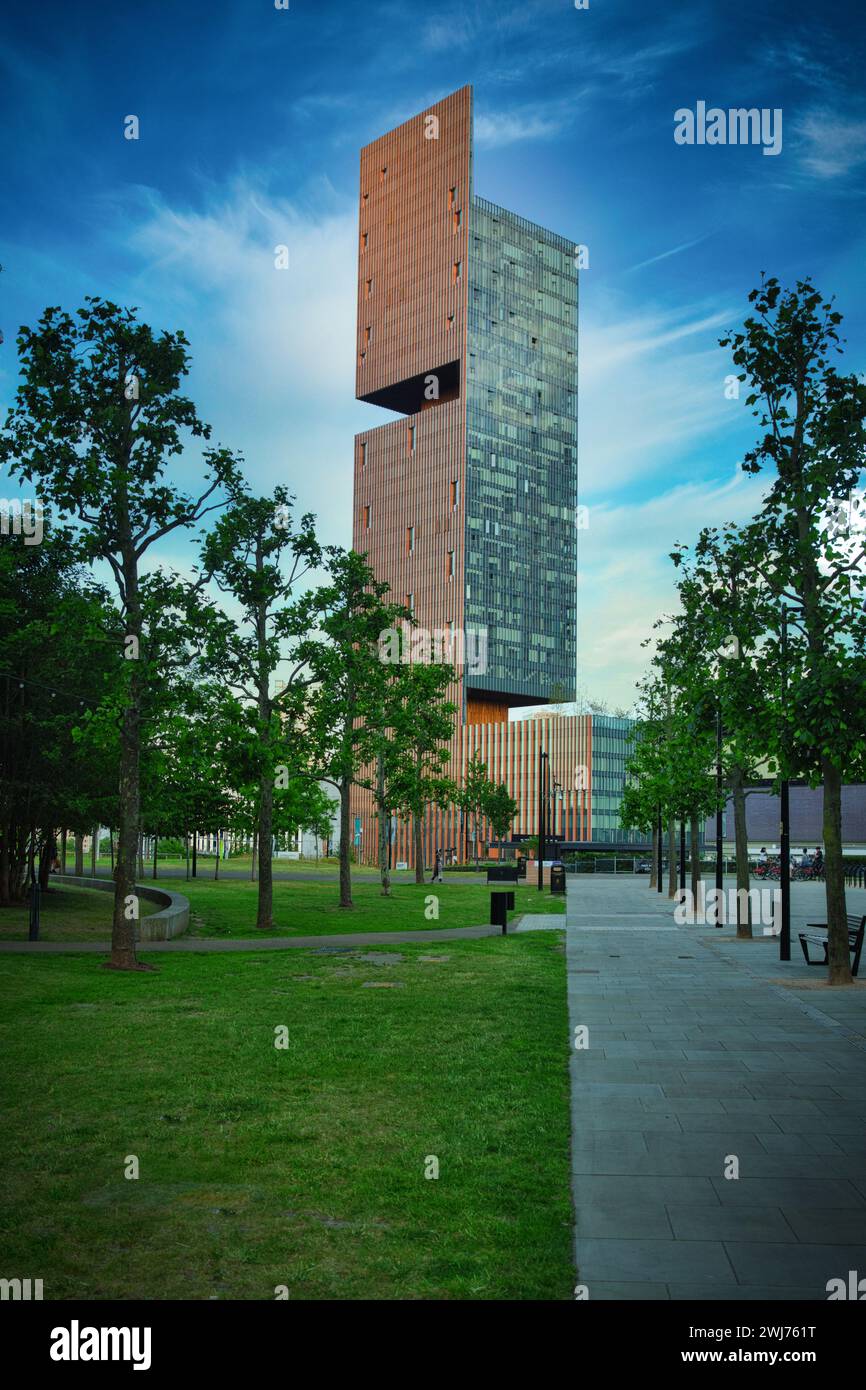 An office building situated on a green lawn alongside a pavement Stock ...