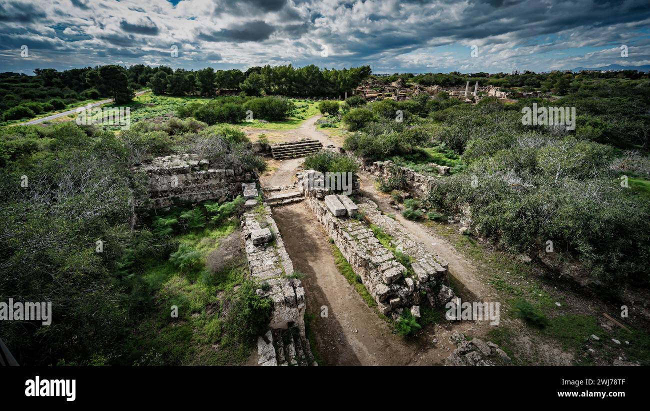 A collection of ancient stone structures atop a lush green meadow Stock ...