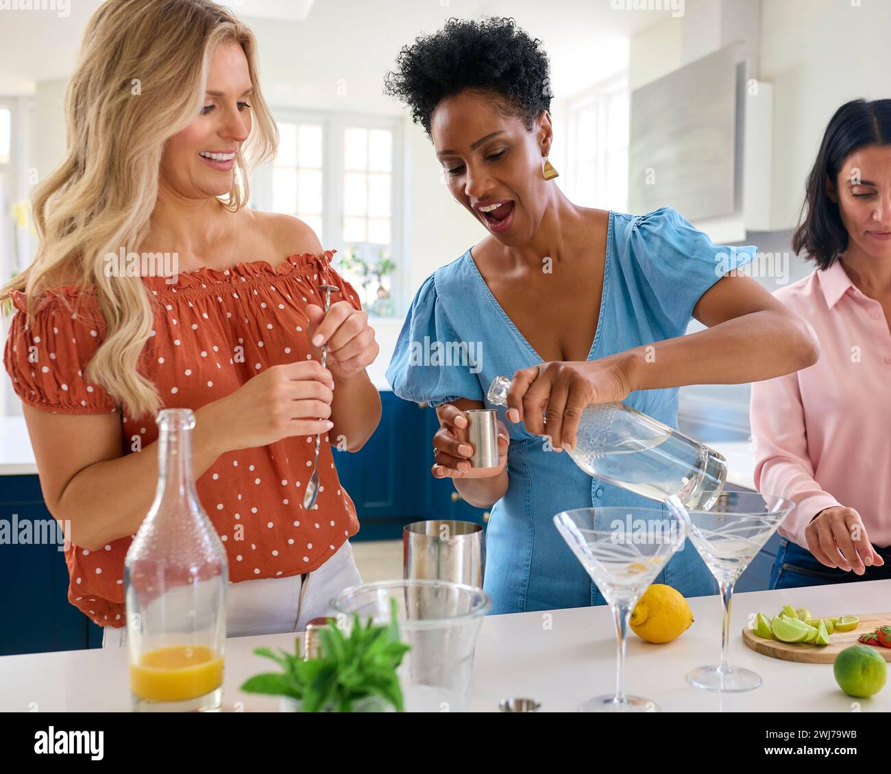 Three Mature Female Friends At Home Having Fun Mixing Cocktails ...