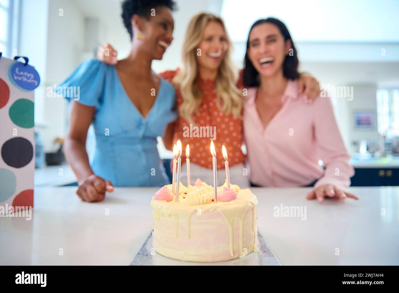 Three Mature Women Meeting At Home To Celebrate Friend's Birthday With ...