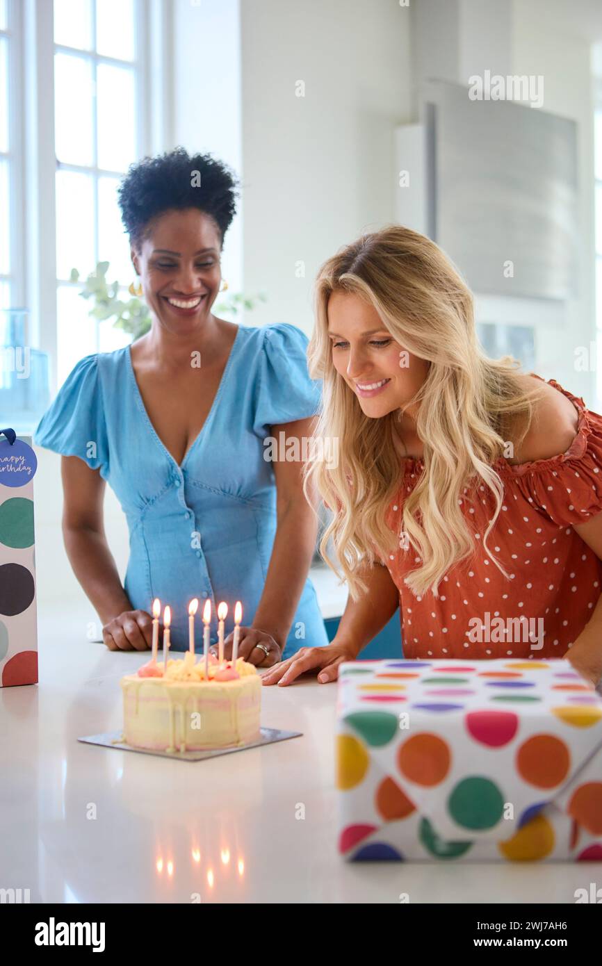 Two Mature Women Meeting At Home To Celebrate Friend's Birthday With ...
