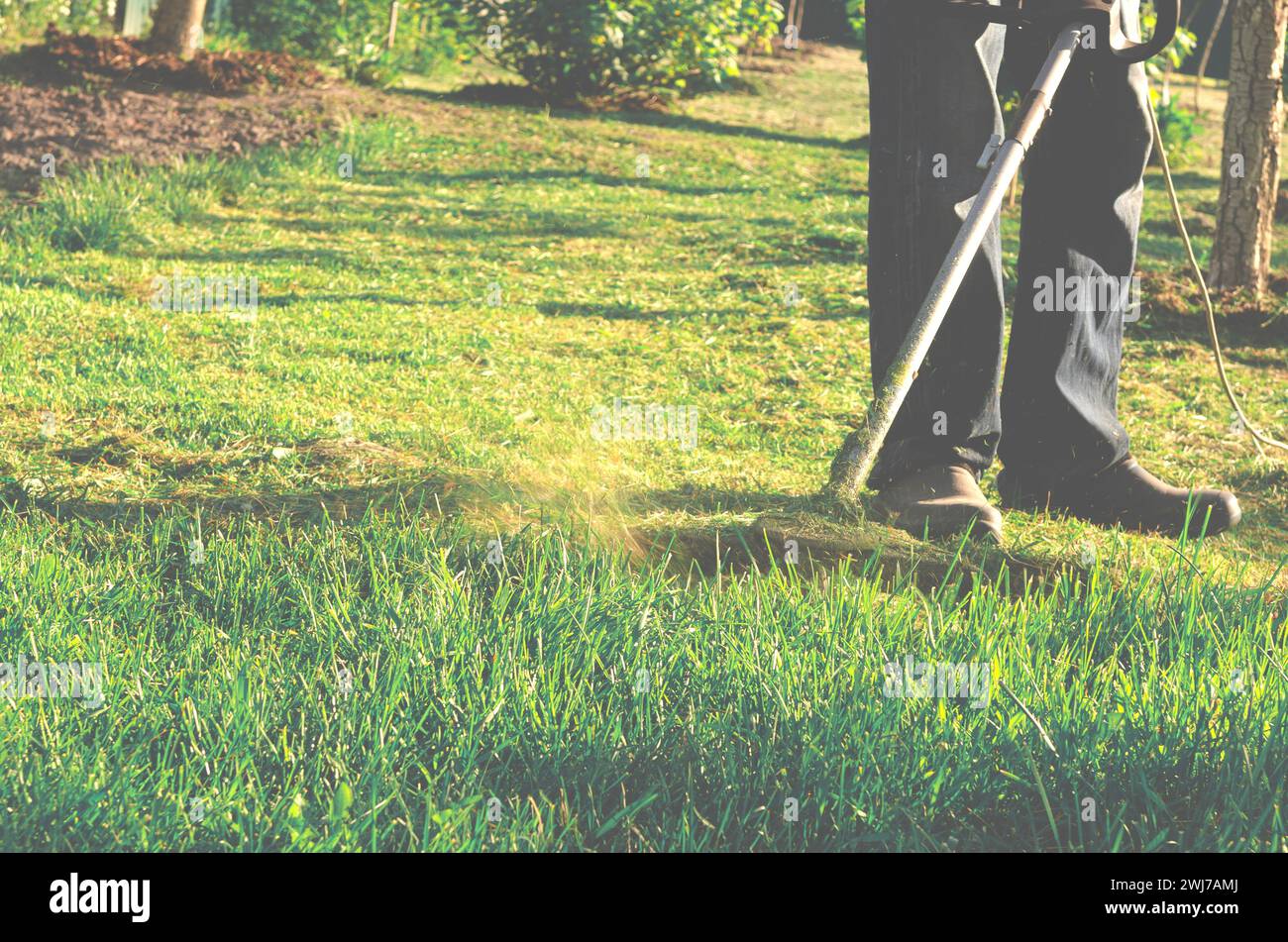 Back view man mowing grass hi-res stock photography and images - Alamy