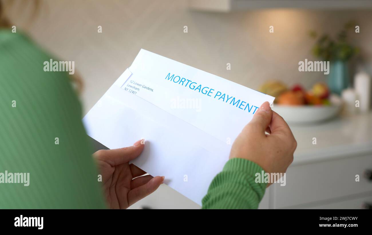 Close Up Of Woman Opening Letter About Increase Repayment On Mortgage ...