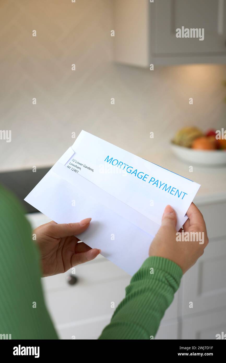 Close Up Of Woman Opening Letter About Increase Repayment On Mortgage ...
