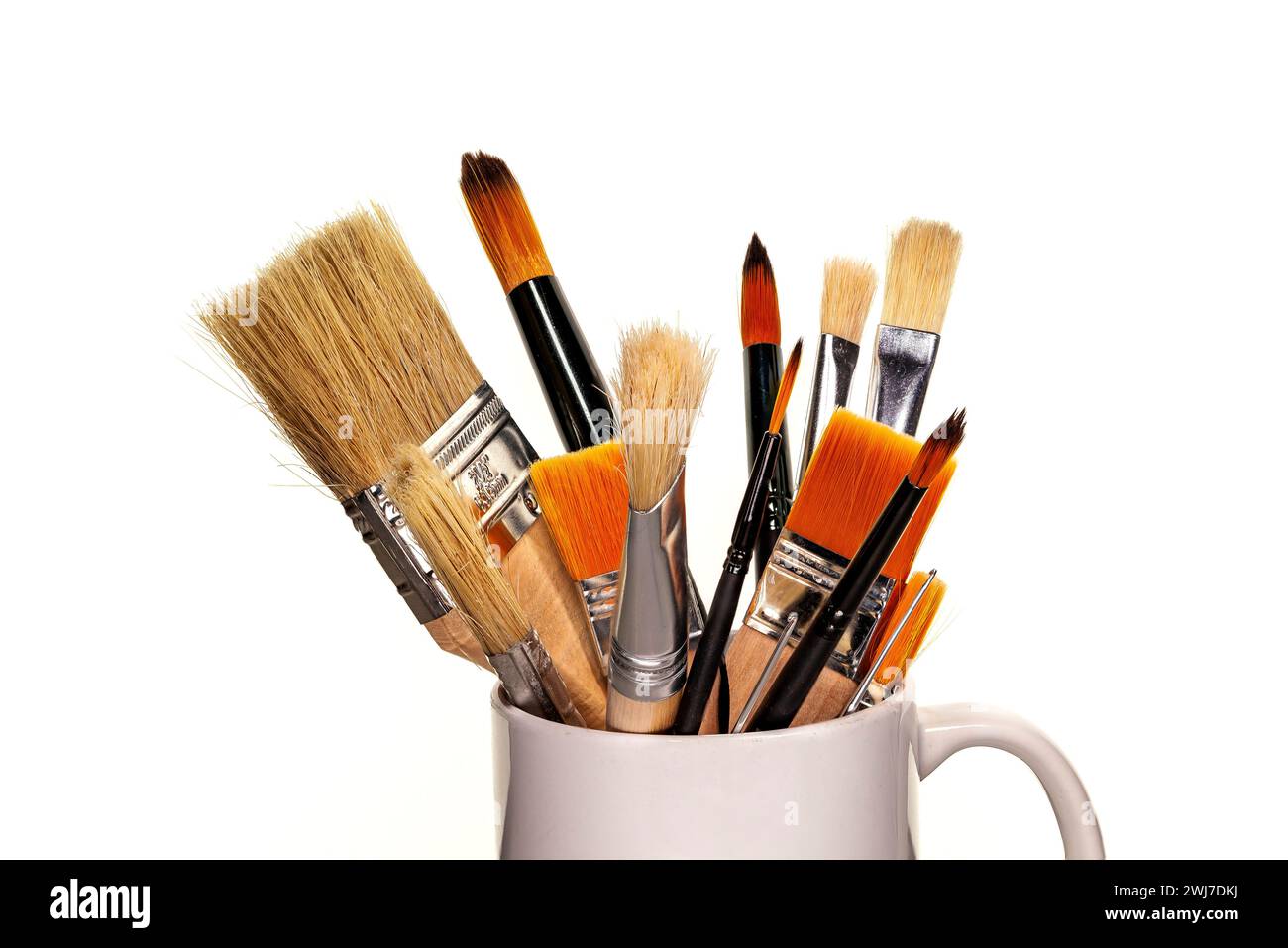 Brushes of different kinds and colors in a vertical position on a white ...
