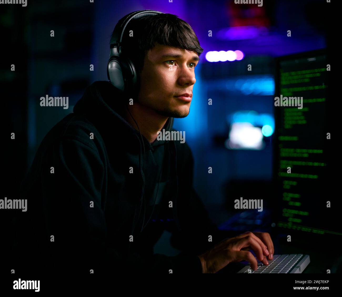 Low Key Lighting Shot Of Male Computer Hacker Sitting In Front Of ...