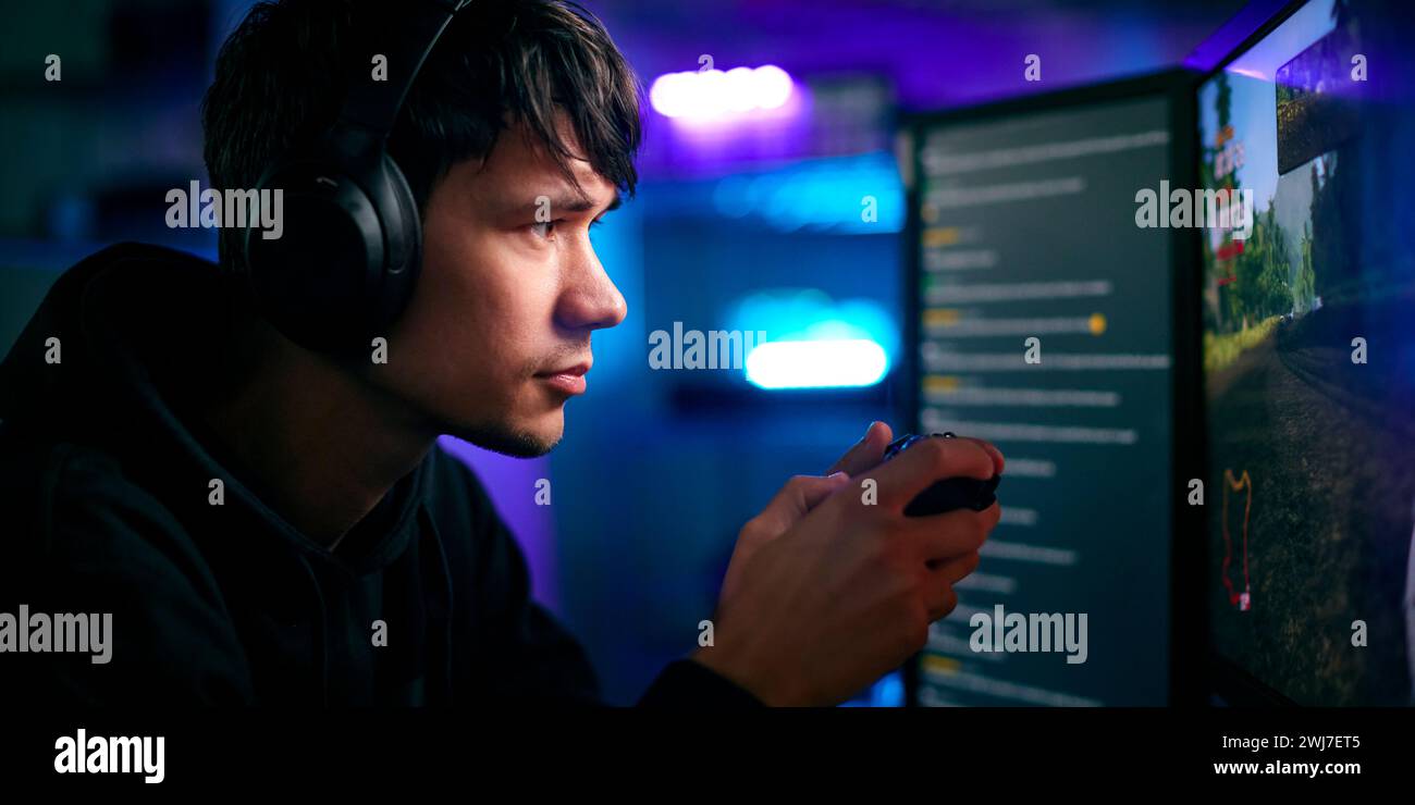 Low Key Lighting Shot Of Male Gamer In Front Of Computer Screens With ...