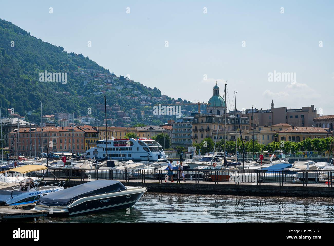 A scenic harbor featuring multiple boats and picturesque buildings ...