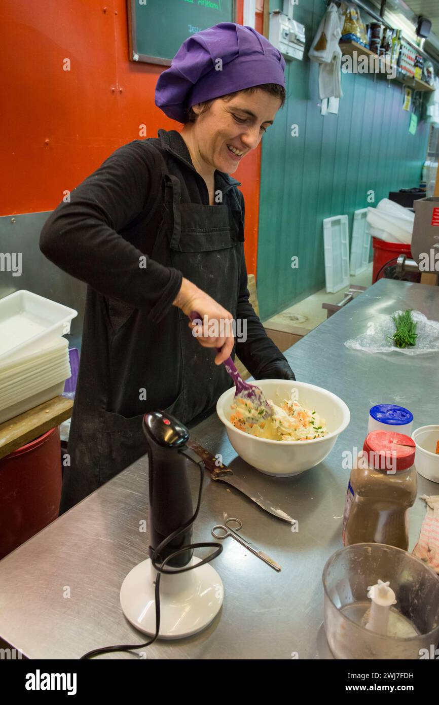 Cook preparing filling for the pasta in her stall of the old Abaceria ...