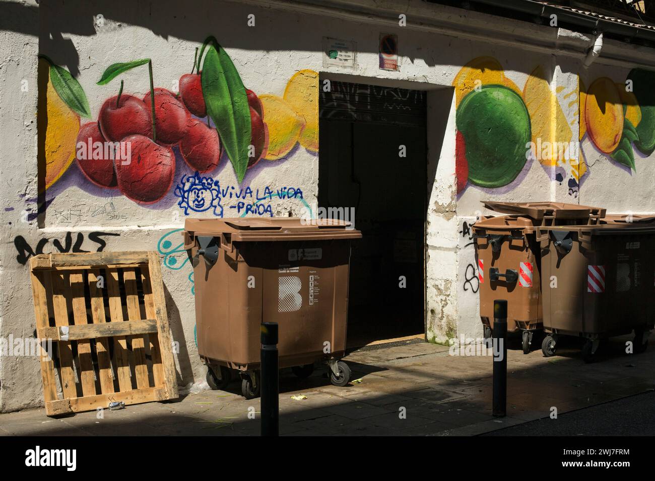 Trash cans beside one of the exterior walls of the Abaceria Central ...
