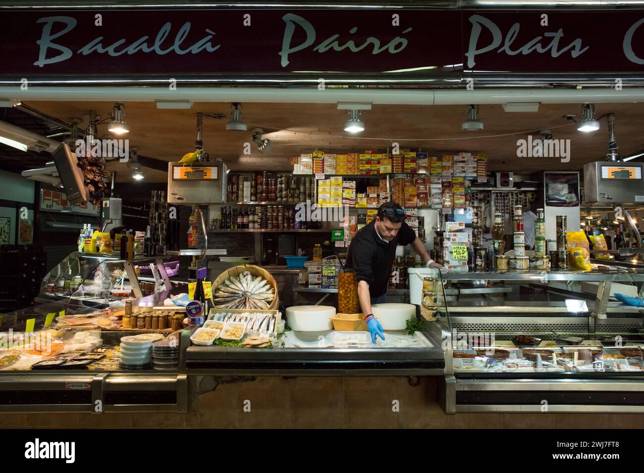 Cod and ready meals stall, with its owner arranging the goods, in the ...