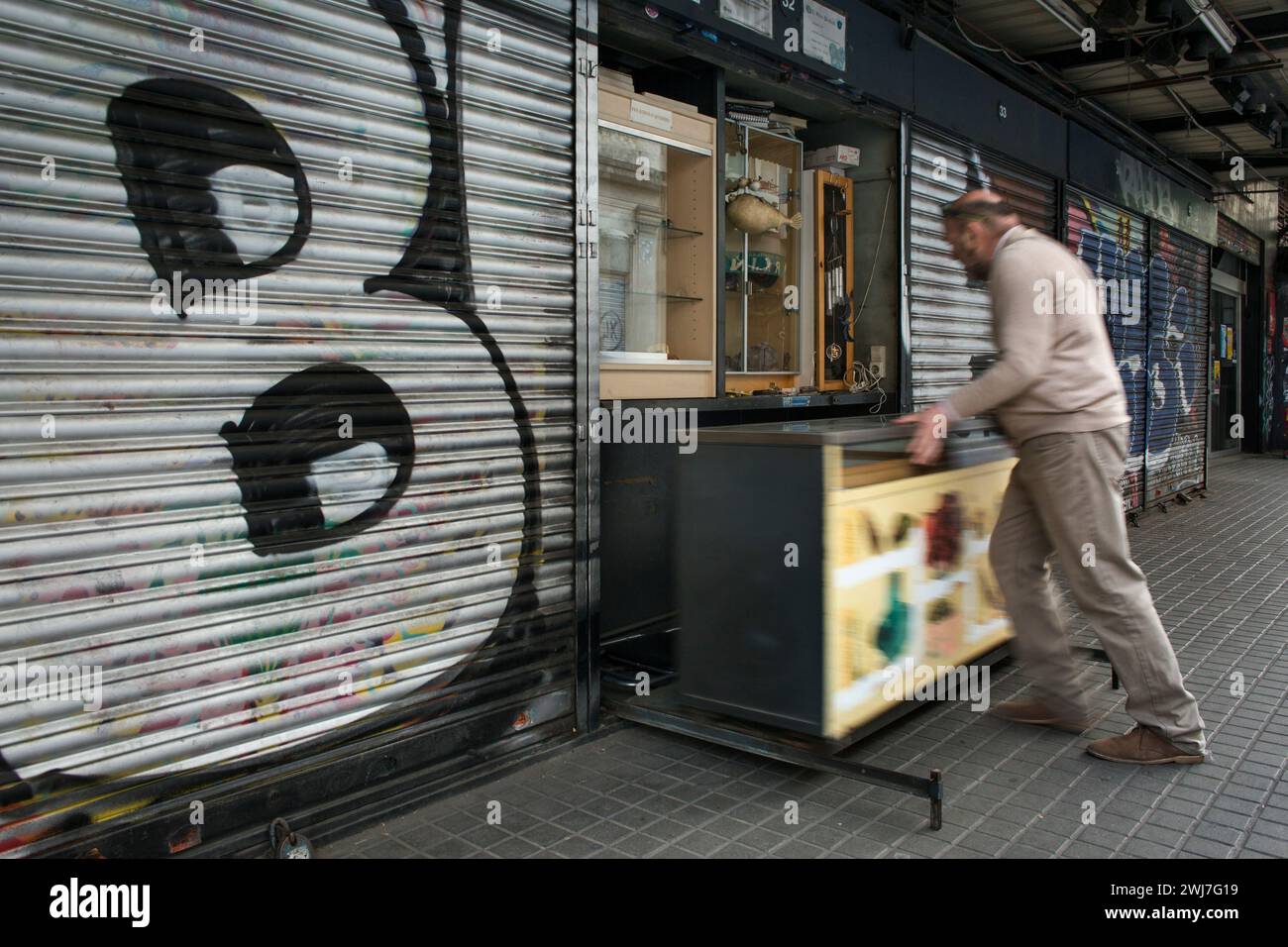 Man closing his exterior stall in the old Abaceria Central Market ...