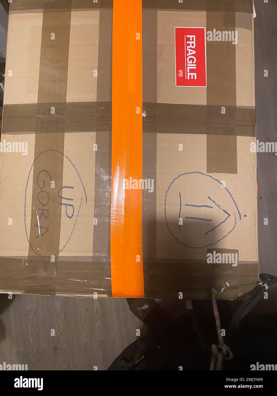 a cardboard box ready for shipping with fragile tag on it , packaging concept high res image ...