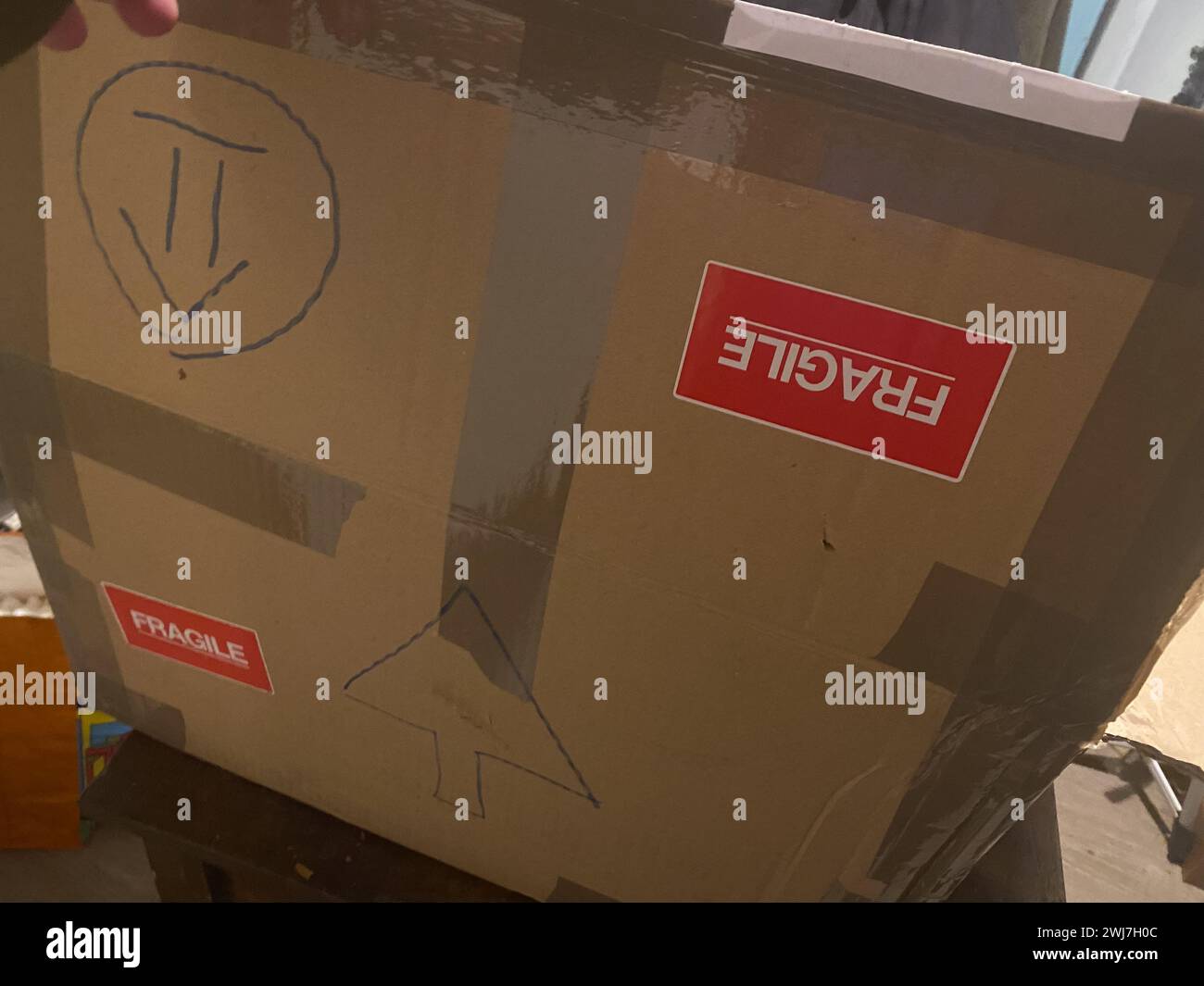 a cardboard box ready for shipping with fragile tag on it , packaging concept high res image ...
