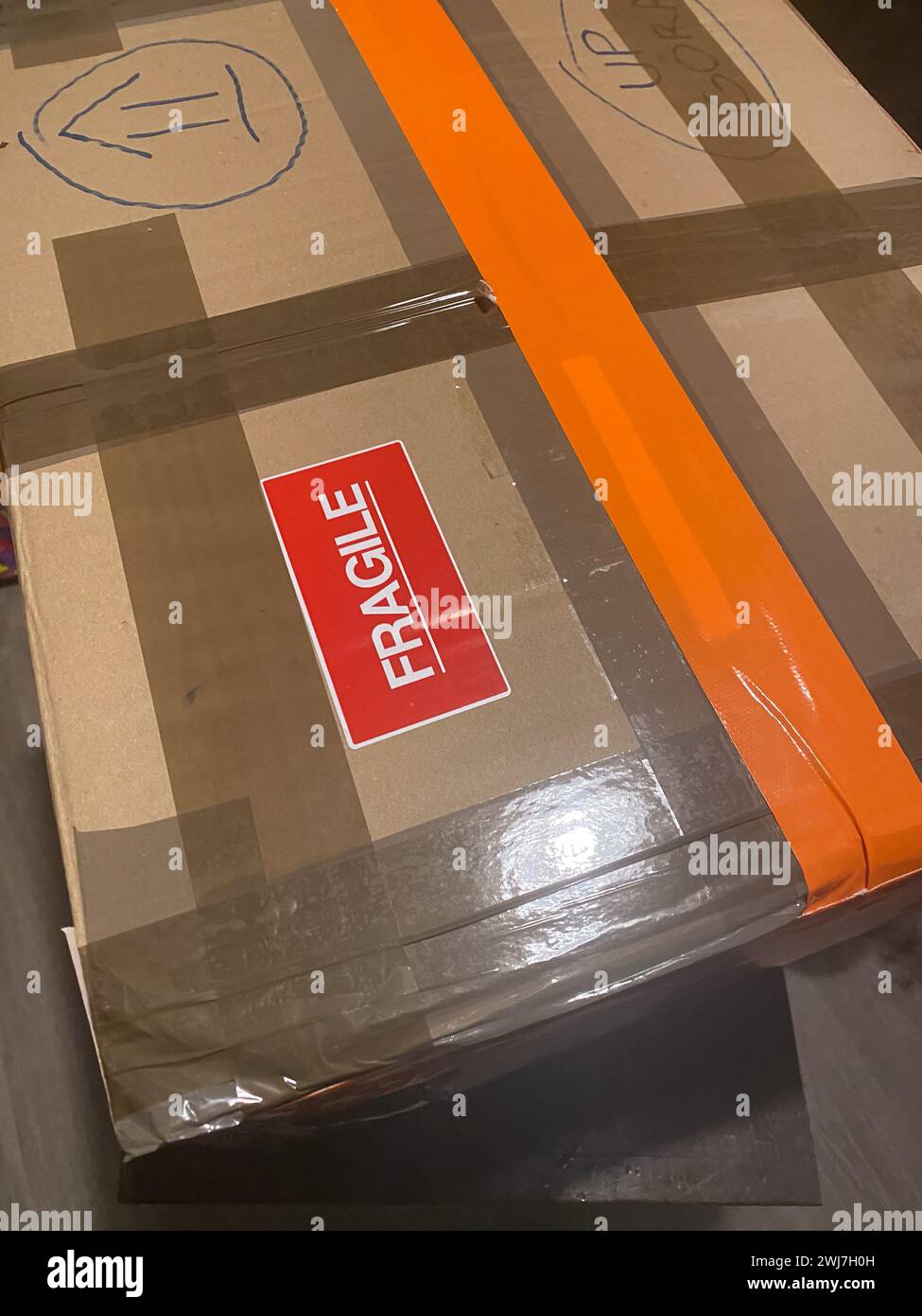 a cardboard box ready for shipping with fragile tag on it , packaging concept high res image ...