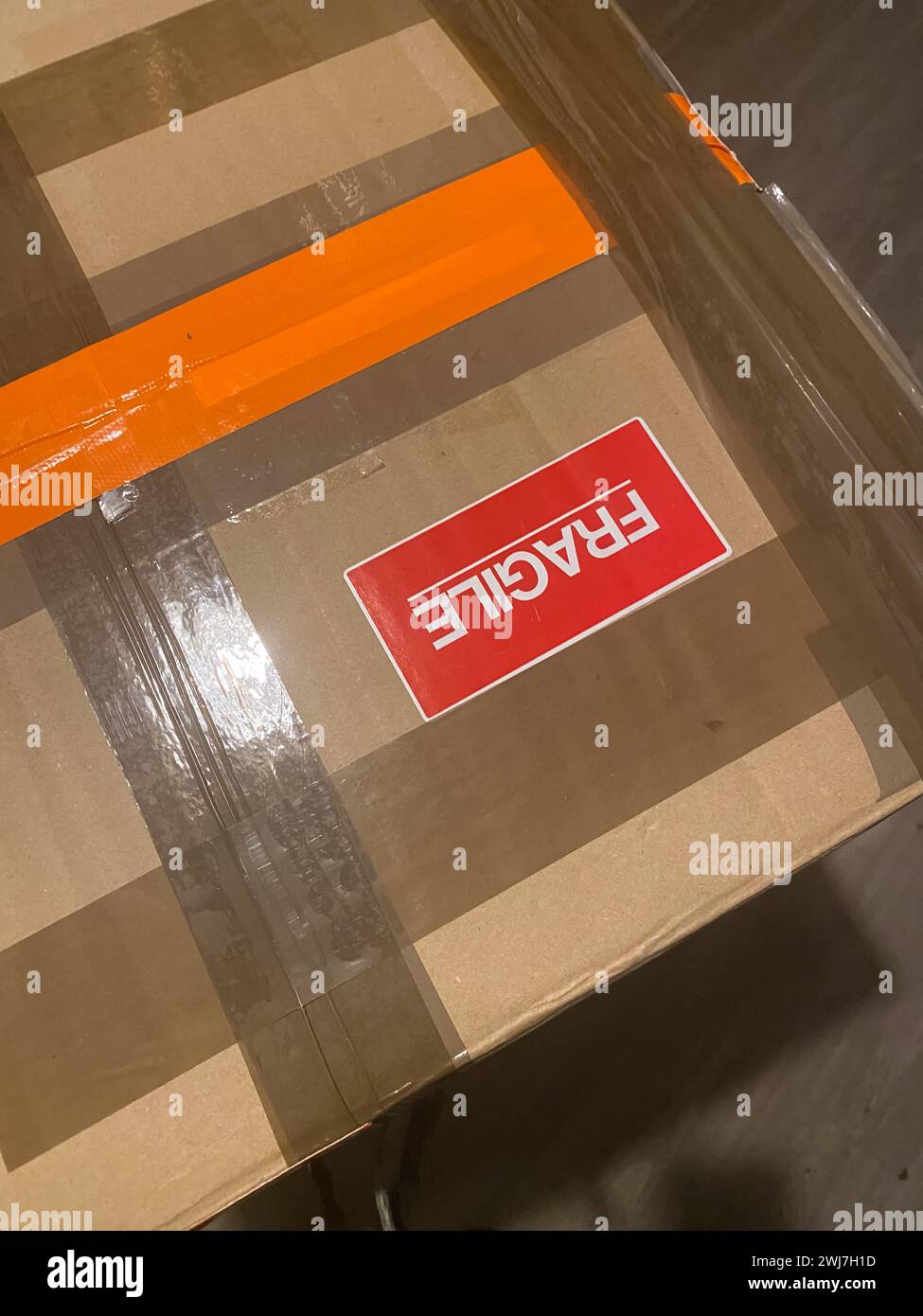 a cardboard box ready for shipping with fragile tag on it , packaging concept high res image ...