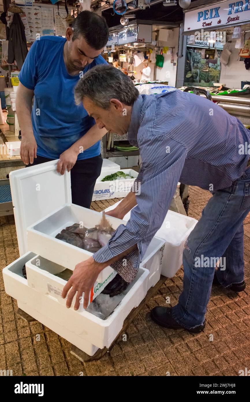 Fishmonger collecting his goods before opening his stall in the old ...