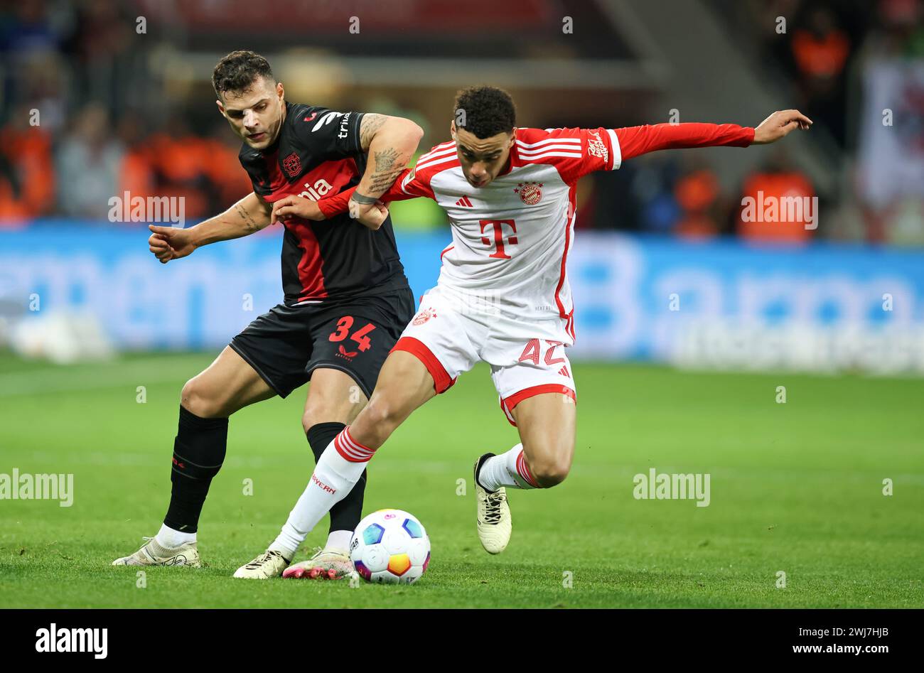 Granit Xhaka of Bayer Leverkusen Jamal Musiala of Bayern Muenchen LEVERKUSEN, GERMANY - FEBRUARY ...