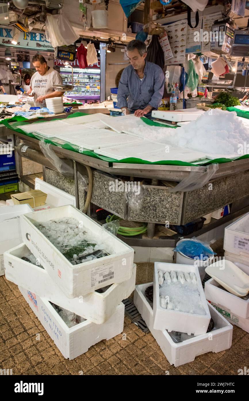 Fishmonger arranging his stall before opening in the old Abaceria ...