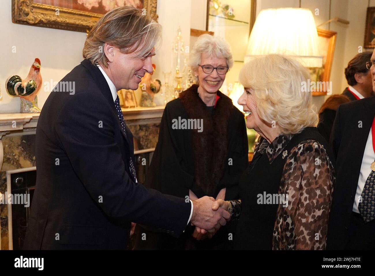 Queen Camilla greets fashion designer Stewart Parvin ahead of a ...