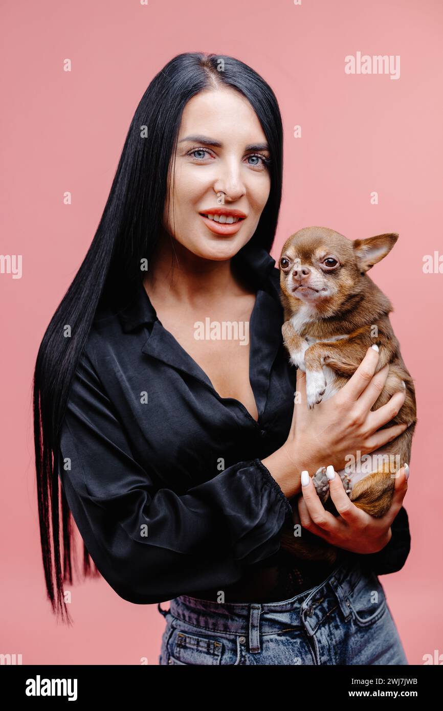 Wonderful european female model chilling in studio with puppy. Indoor ...