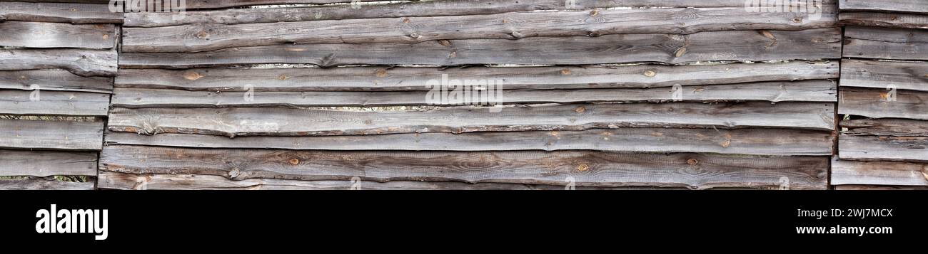 Background of an old wide wooden fence. Texture of a rustic fence made ...