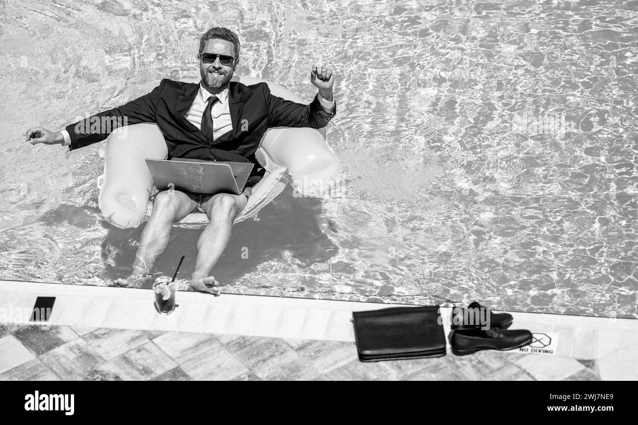 photo of man trader work and relax in pool with laptop, advertisement ...