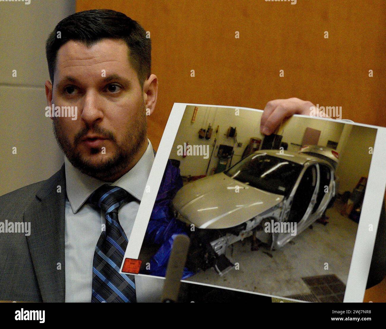 Former Manchester Police Officer Joseph Tucker holds up a photograph of ...