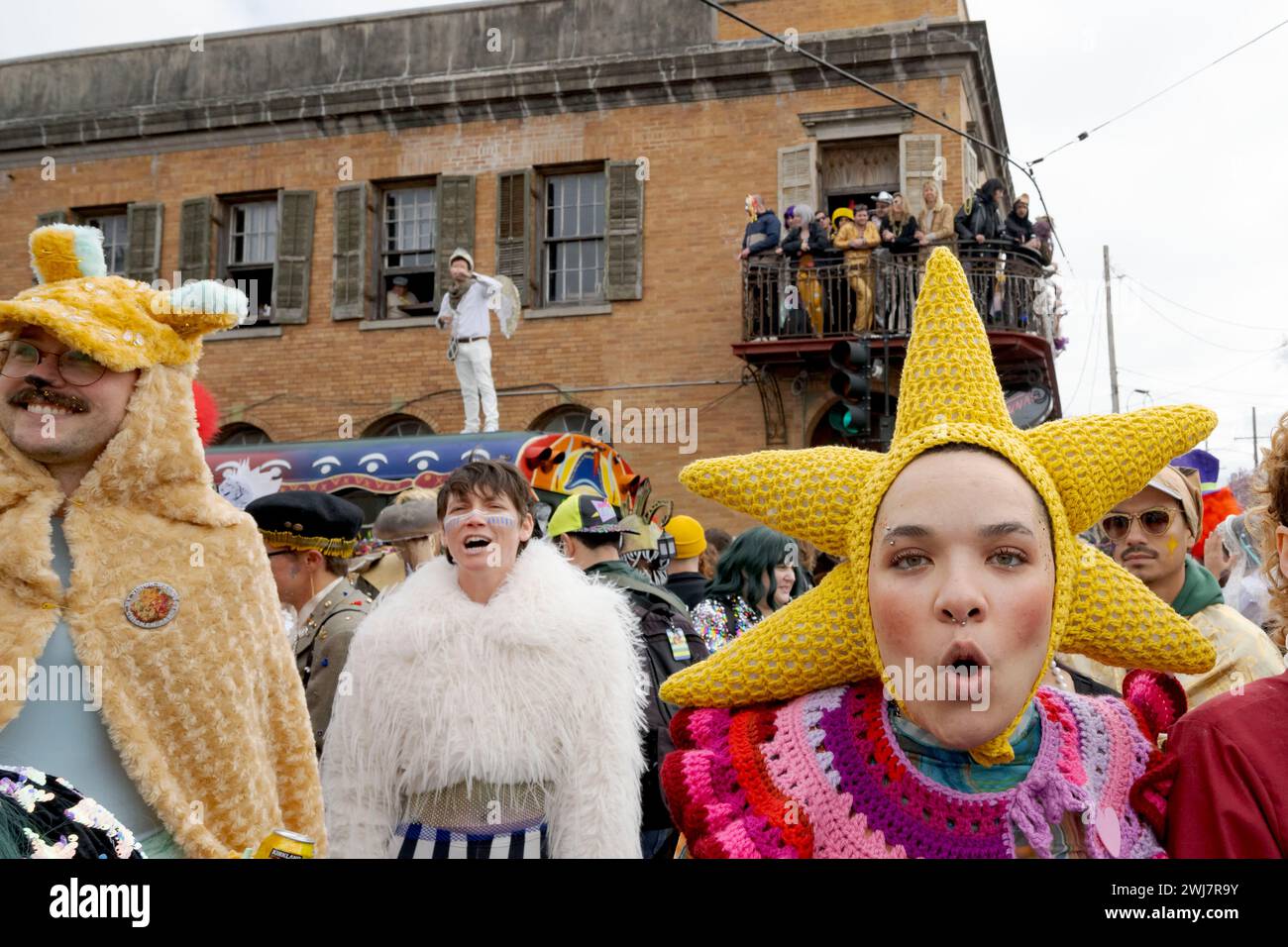 People walk in costumes during the Society of Saint Anne parade through ...