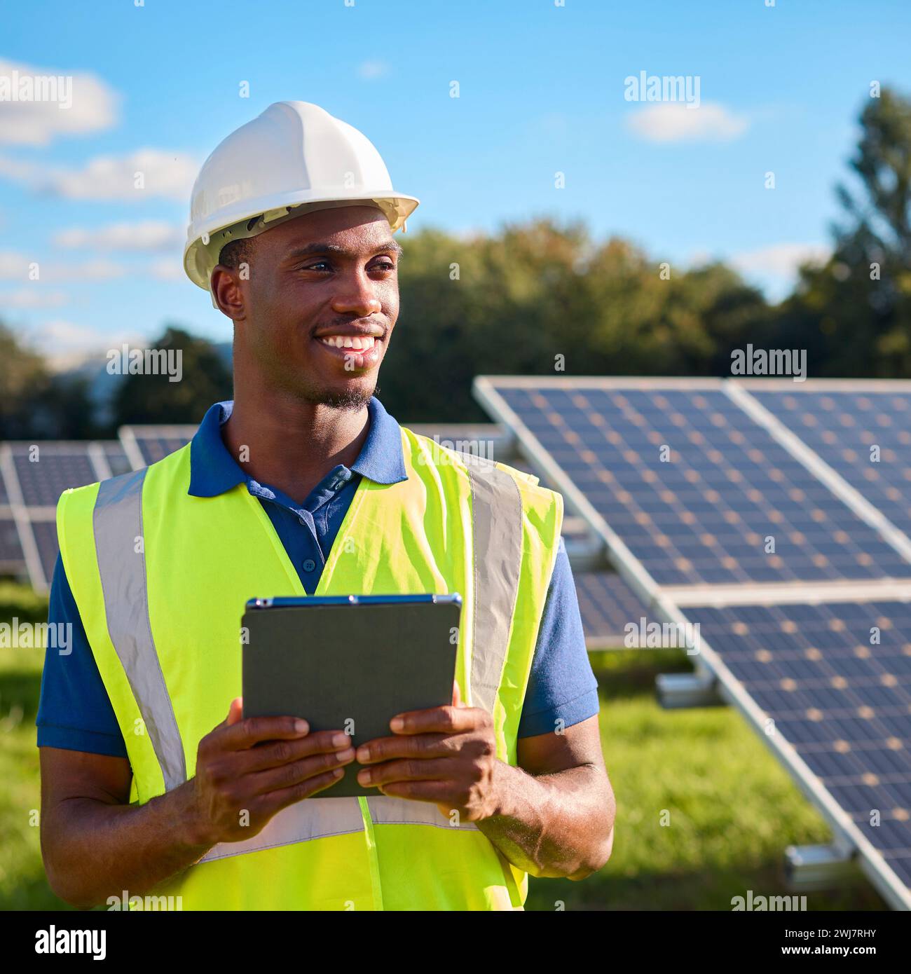 Portrait Of Male Engineer With Digital Tablet Inspecting Solar Panels ...