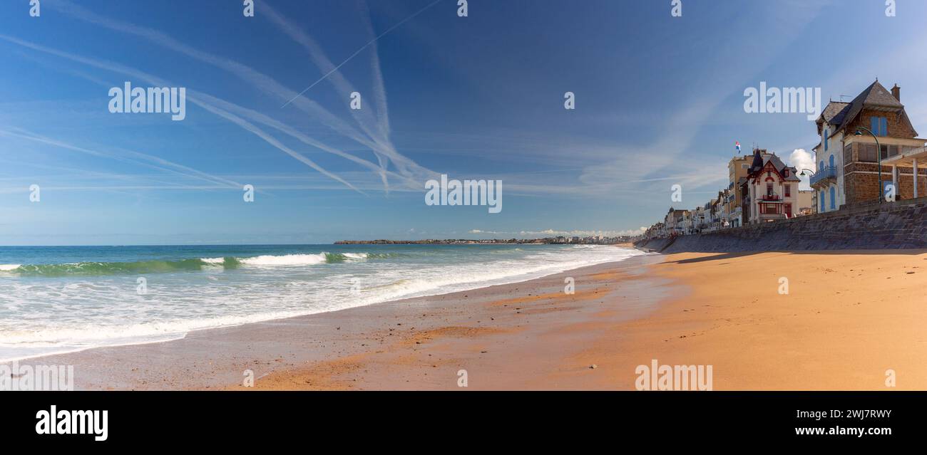 High stone embankment and beach at high tide, in beautiful Saint-Malo ...
