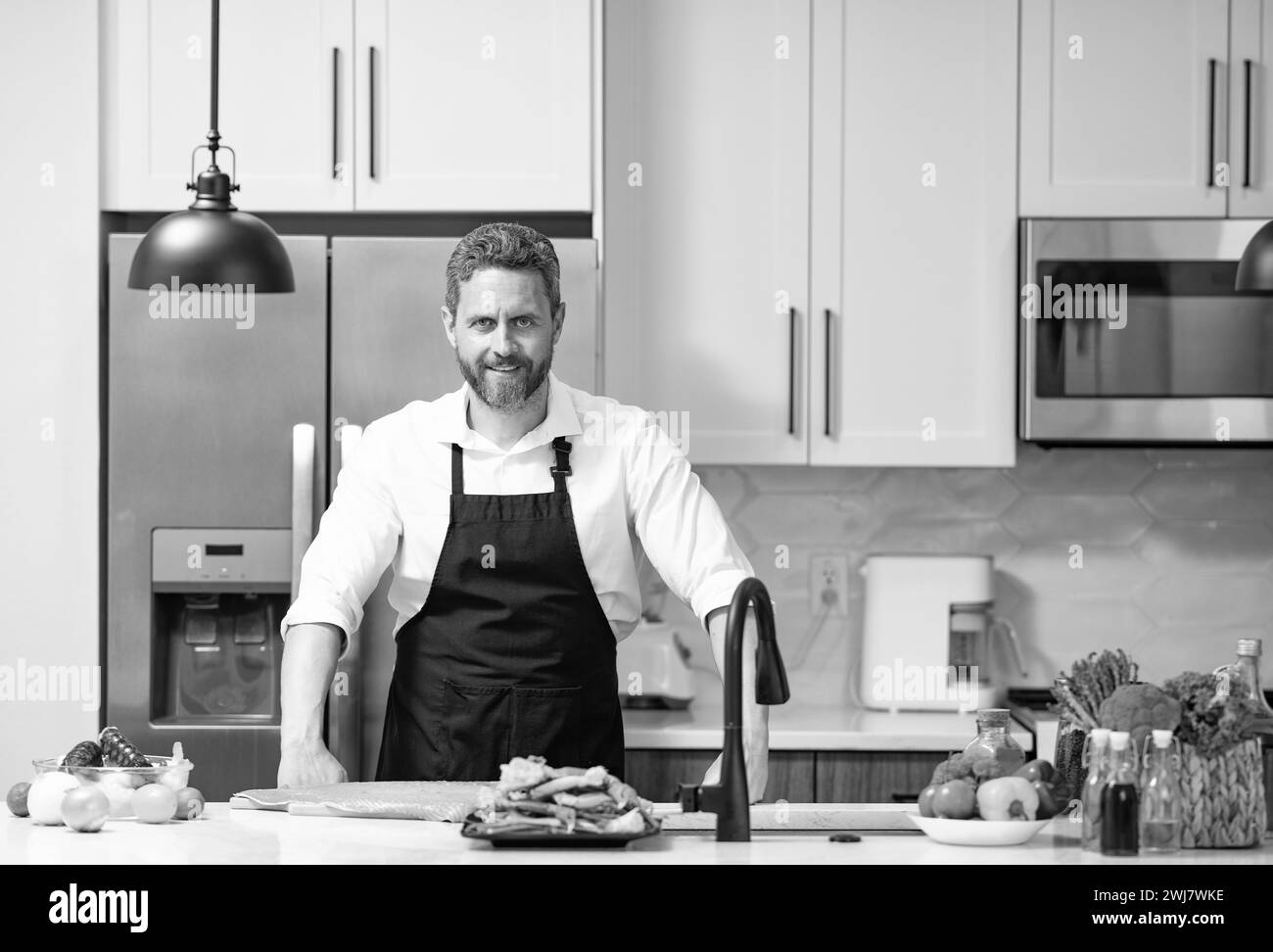 man cooking healthy food, copy space. man cooking healthy food wearing ...